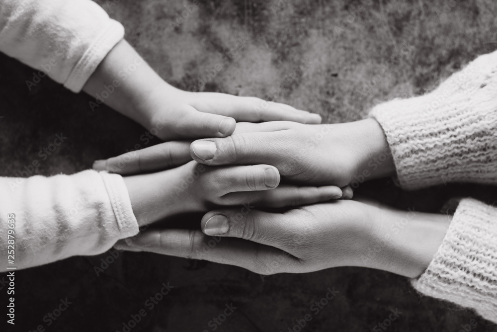 Close up view of family holding hands, loving caring mother supporting ...