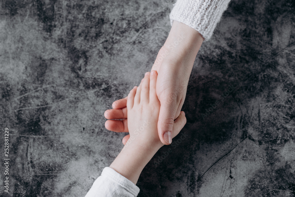 Close up view of family holding hands, loving caring mother supporting ...