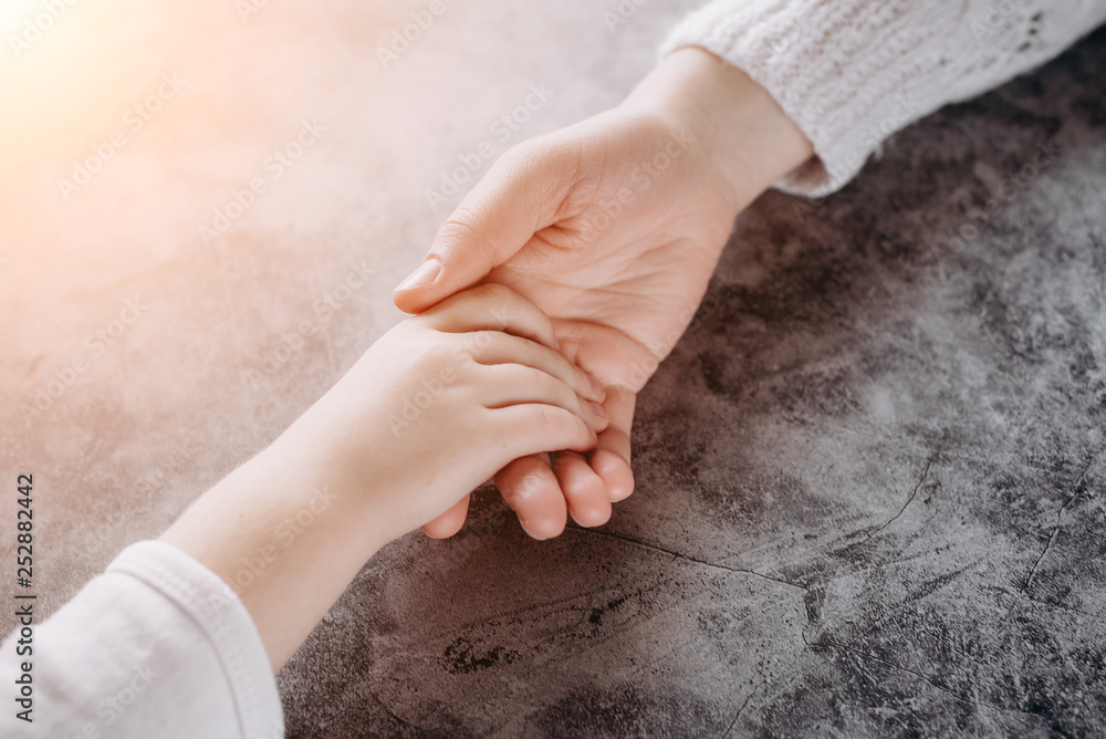 Close up view of family holding hands, loving caring mother supporting ...