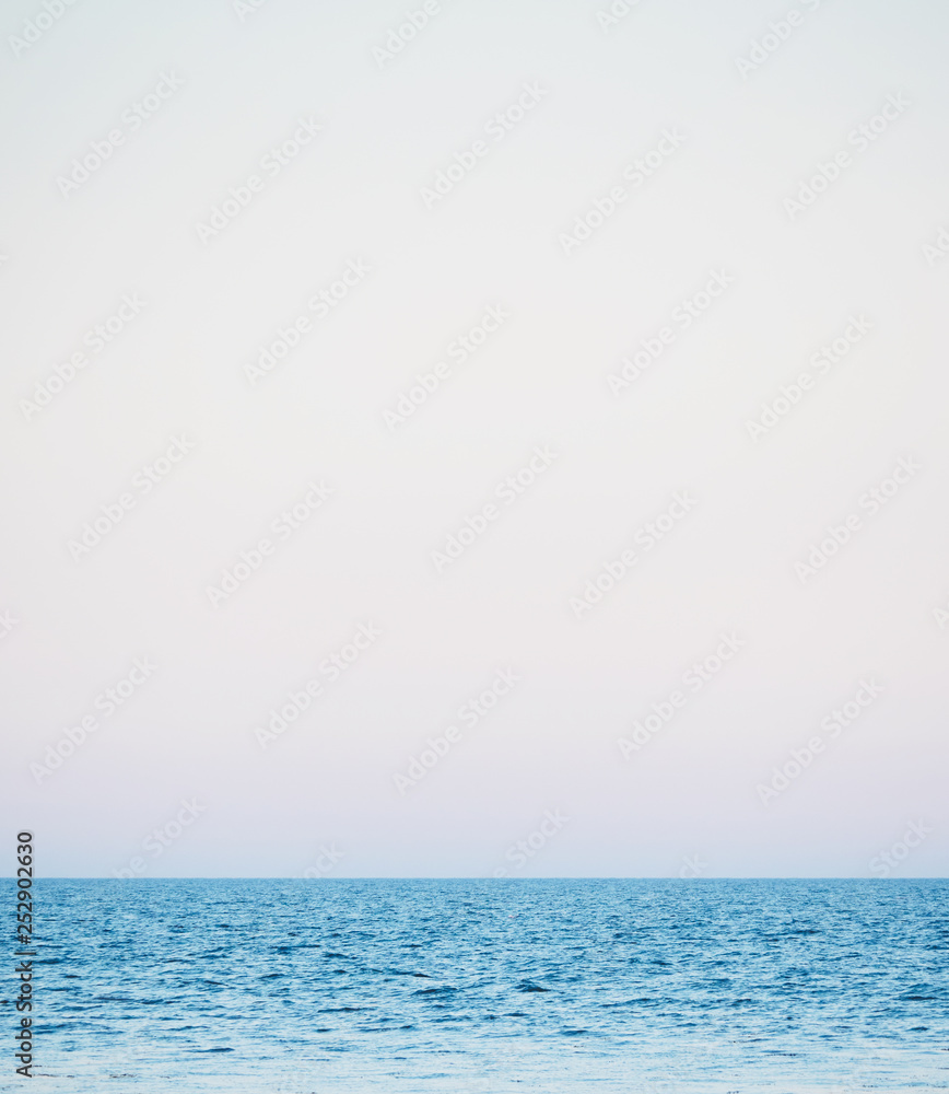 A clean image of a blue ocean and a clear sky in portrait mode, perfect ...