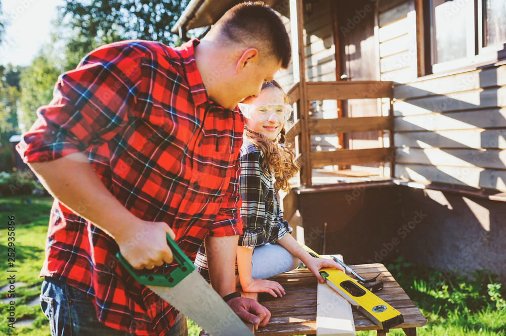 father teaching kid daughter to use tools. Girl helping dad with ...