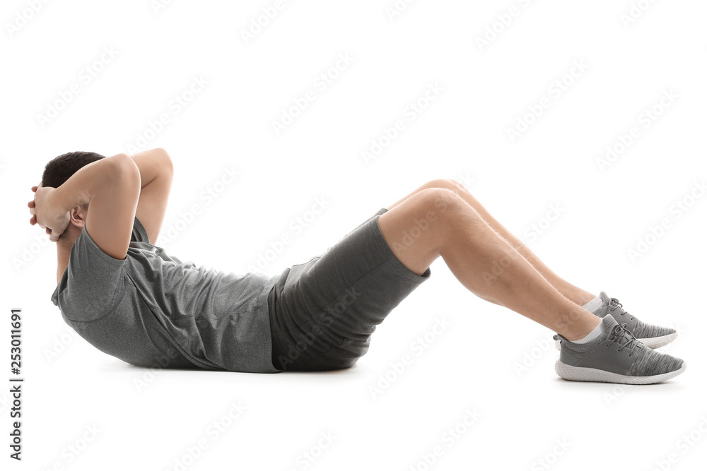 Sporty young man doing crunches against white background Stock Photo ...