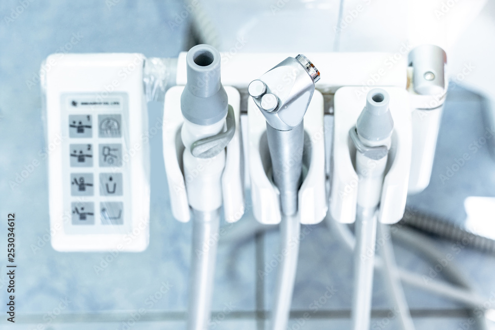 Professional dental instruments and control panel on dental chair in ...