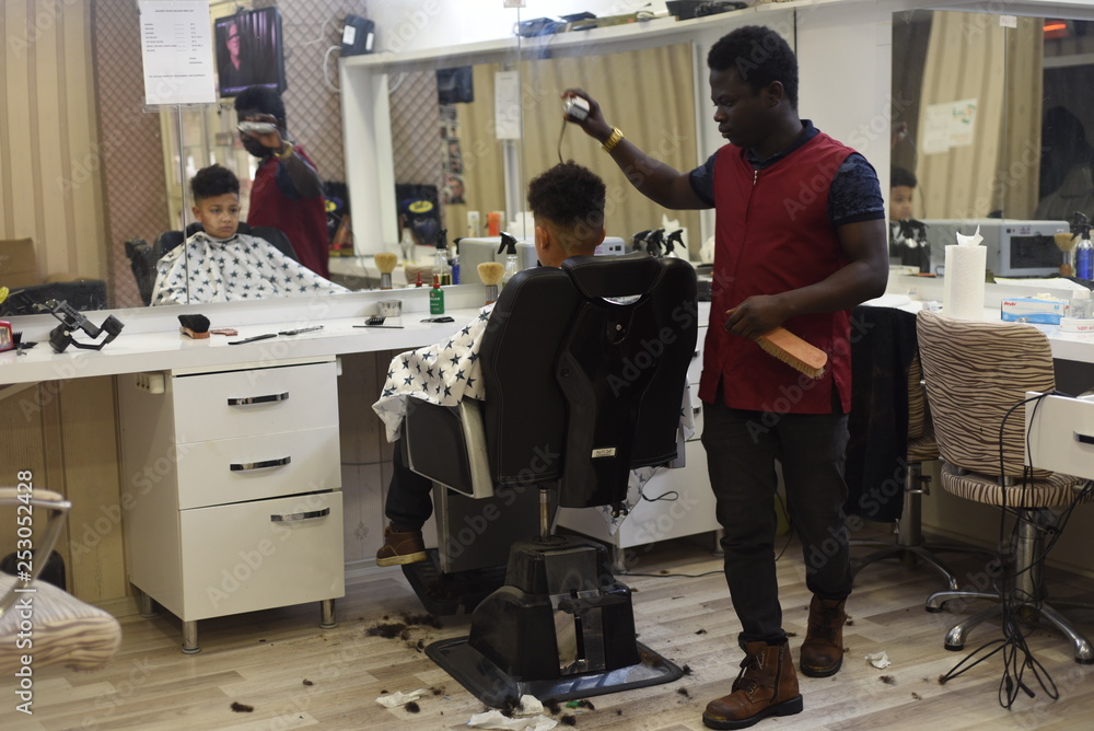 Cute african american boy in the african barbershop. Cute mixed boy ...