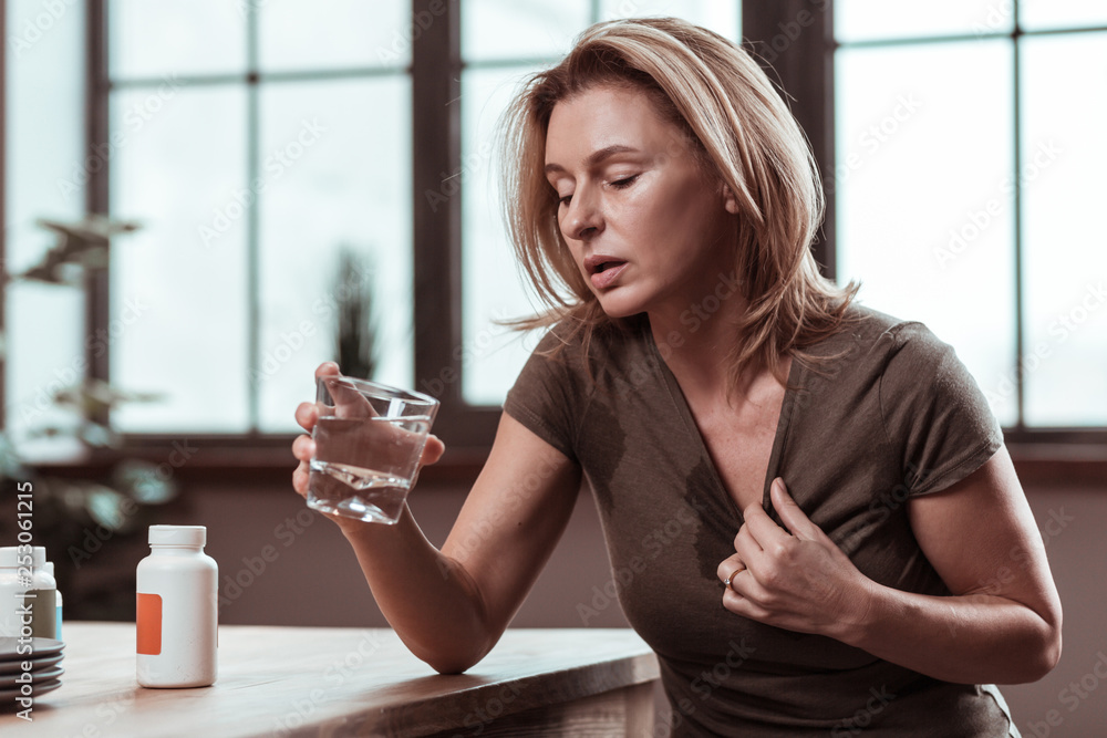 Blonde woman suffering from depression drinking water Stock Photo ...