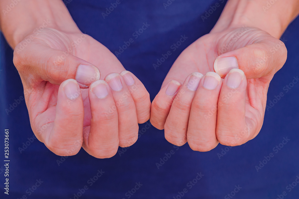 Man's finger nails are clean, Men's hand with a long nail on a blue ...