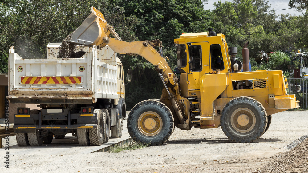 front end loader loading a dump truck on a weigh bridge Stock Photo ...