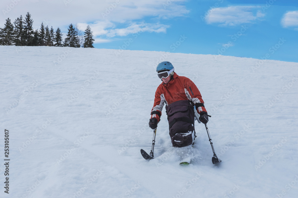 handicapped athlete goes downhill skiing, disabled skier and disability ...