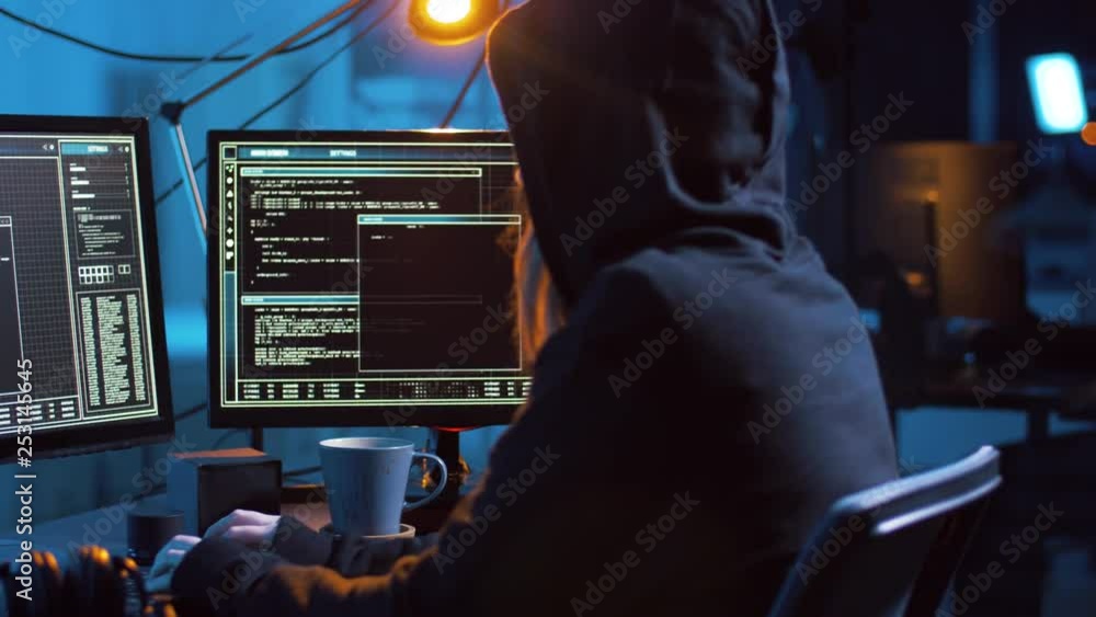 cybercrime, hacking and technology concept - female hacker in dark room creating code or using ...
