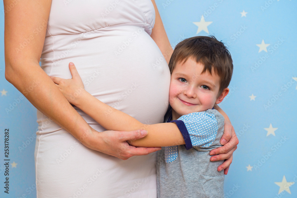 Cute child hugging belly pregnant mother. Happy kid hugging pregnant ...