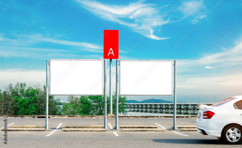 Car parking space and empty advertising board near the sea, mountain ...