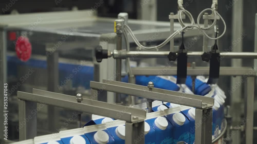 Dairy products, paper bags of milk are transported on a conveyor. Stock ...