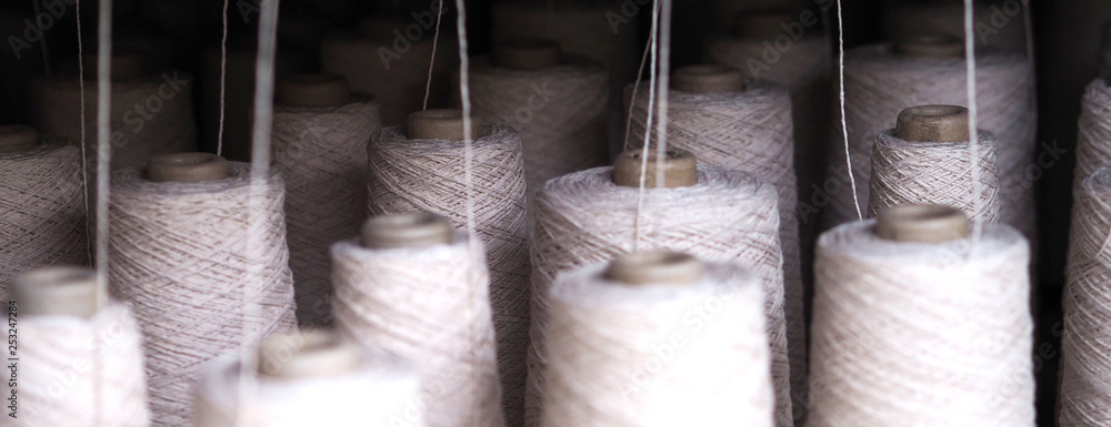 Row of textile threads industry . Stock Photo | Adobe Stock