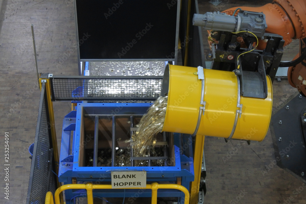 Money robot arm pouring coins in the Royal Australian Mint Canberra ...