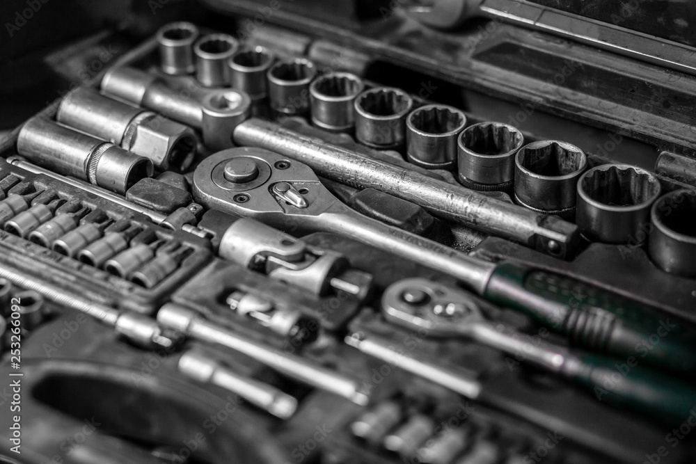 Flat Lay metal tools: wrenches, ratchet, a set of interchangeable heads ...