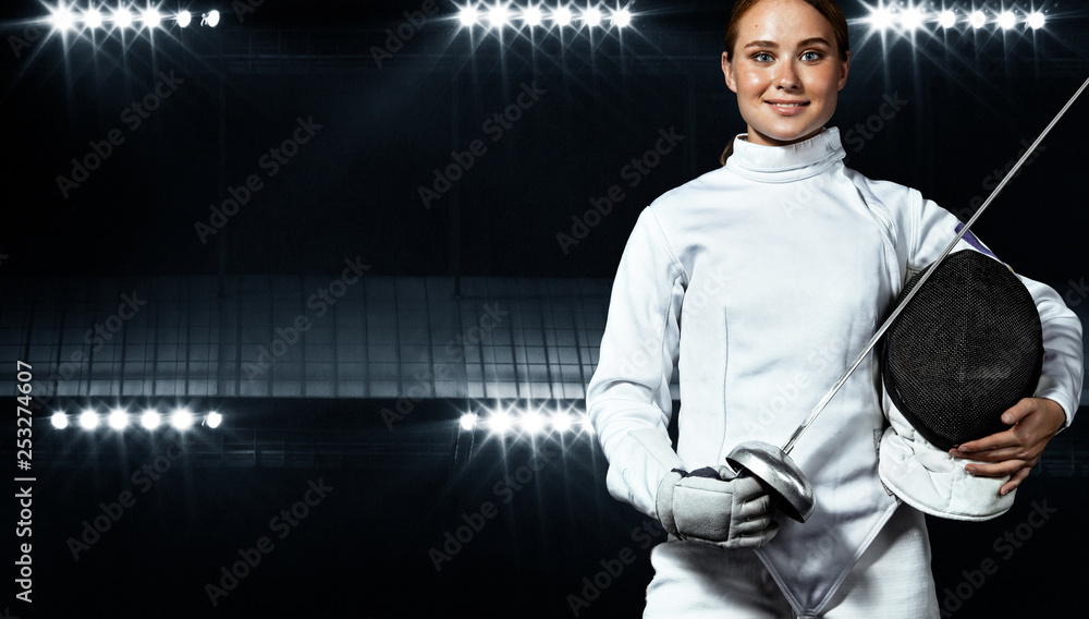 Young fencer athlete wearing fencing costume holding the sword and mask ...