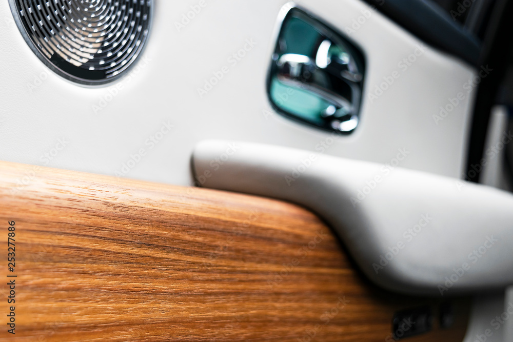 Door handle with power window control buttons of a luxury passenger car ...