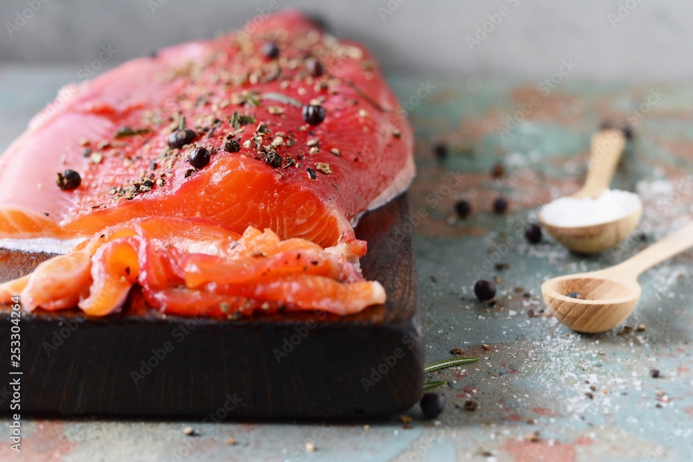 Gravlax, scandinavian beet cured spiced salmon on the board, top view ...