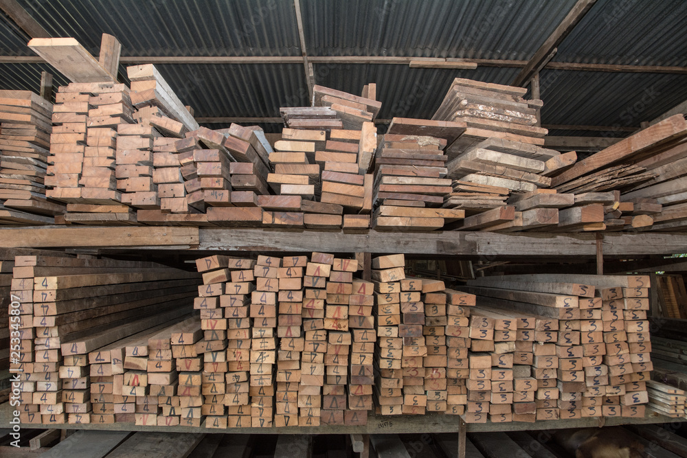 Piles of old wooden boards in the sawmill, Warehouse for sawing boards ...