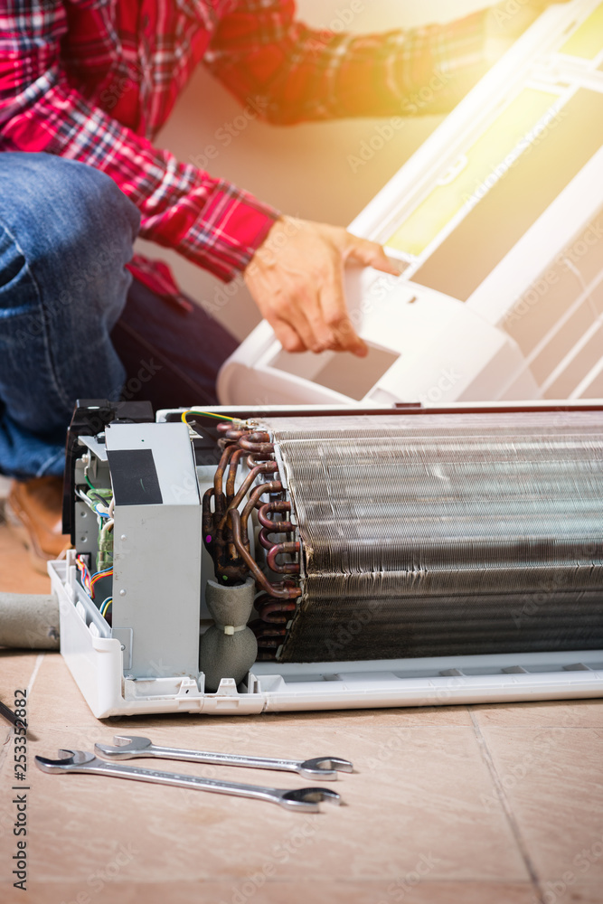 repairing the air conditioner Stock Photo | Adobe Stock