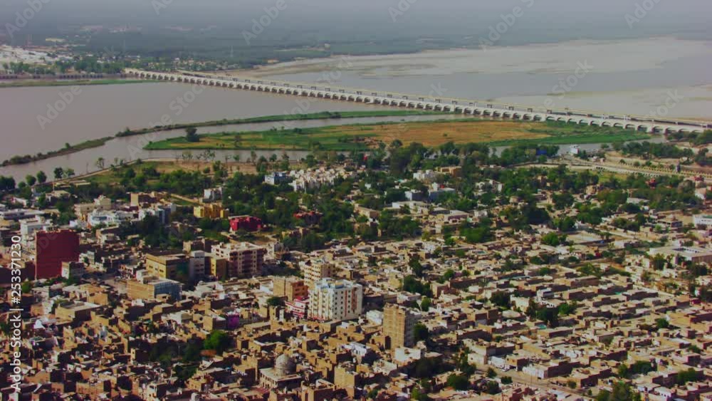 Aerial view of river and city with electric towers in river, Buildings ...