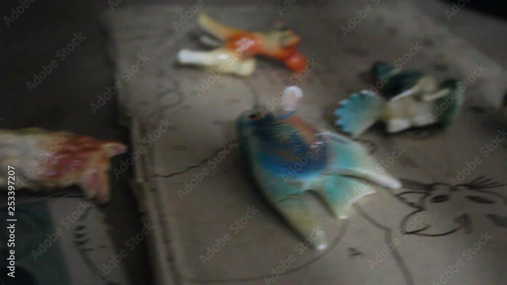 Scary looking porcelain dolls scattered across scary looking clown ...