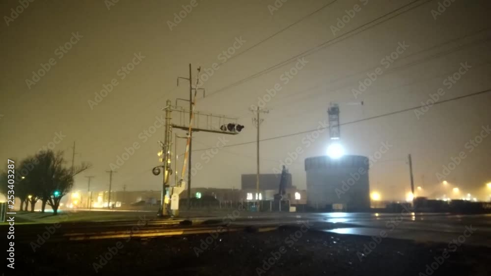 Light foggy night time lapse. Train tracks in the shot. 2 trains in the ...