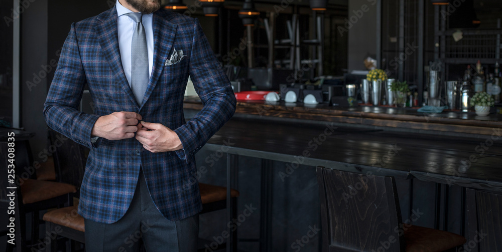 Man in expensive custom tailored suit standing and posing inside of a ...