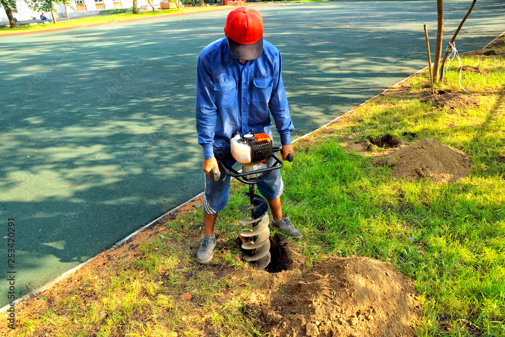 Drilling holes in the ground. Stock Photo | Adobe Stock