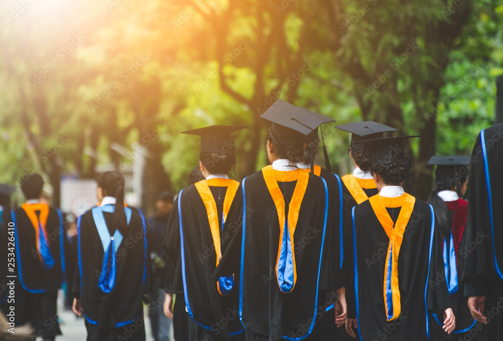 Education theme concept. Back view of Graduates during commencement ...
