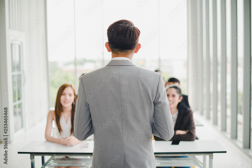 Asian male speaker is speaking at seminars and workshops to the people ...