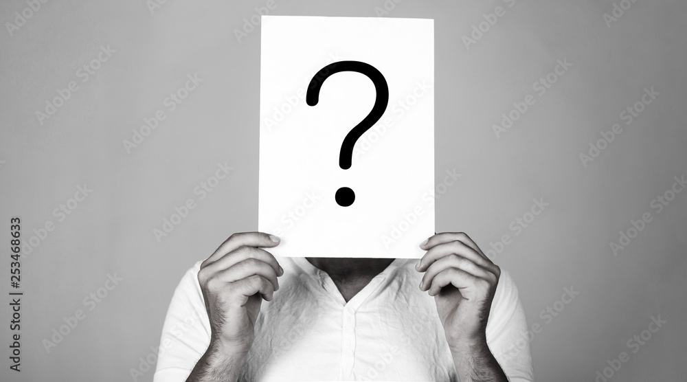 Man a question. Doubtful man holding Question Mark. Problems and ...