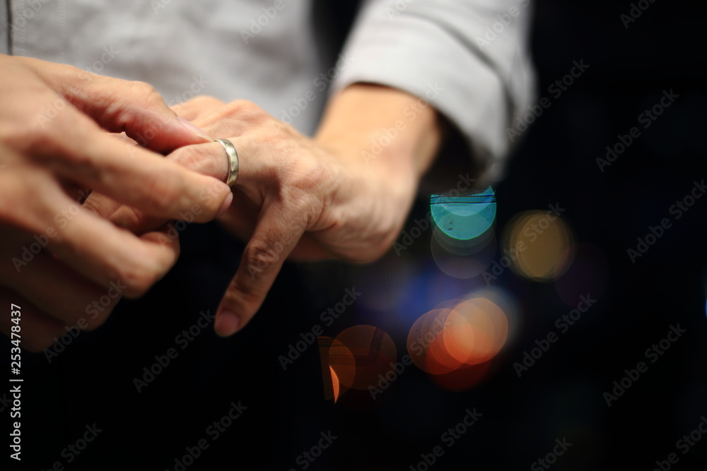 man putting on wedding ring. close up shot of man fidgeting ring with ...