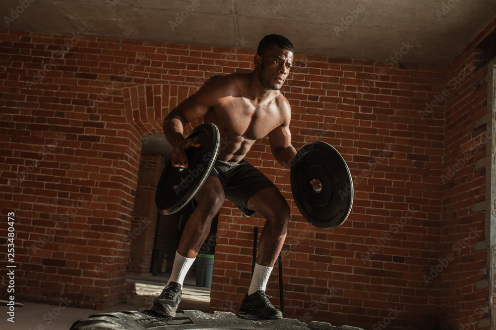 Powerful strong african fighter boxer practicing Weighted Jumps with ...