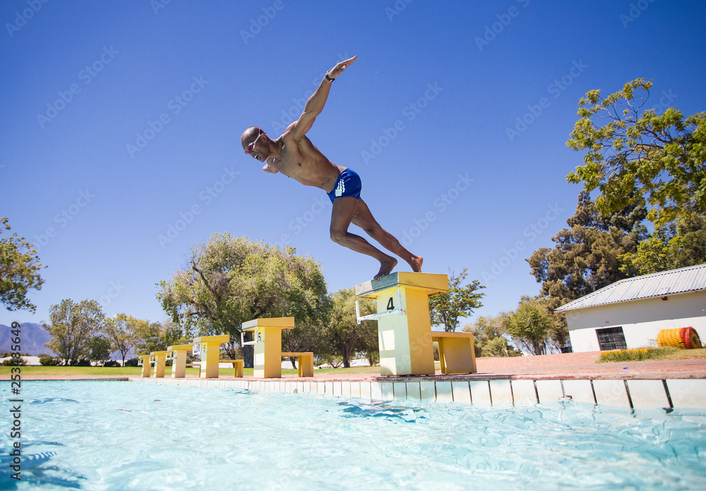 Underwater image of a male swimmer diving and swimming in a swimming ...