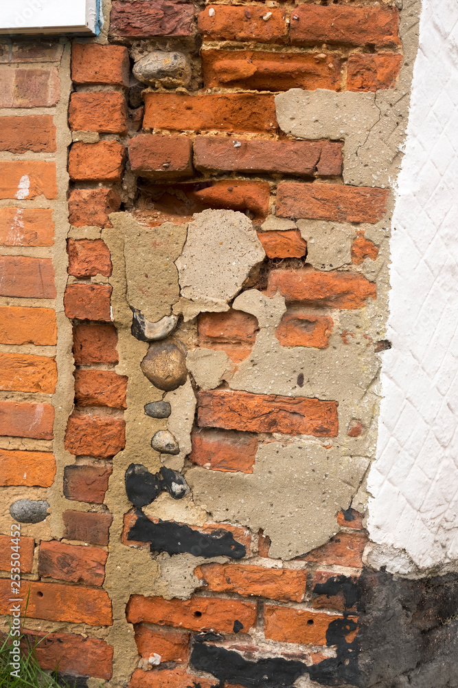 Old crumbling repaired red brick wall Stock Photo | Adobe Stock