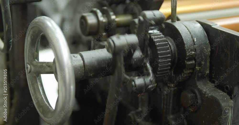 Mechanism with rotating gears. The cogs are turning the ink rollers on ...
