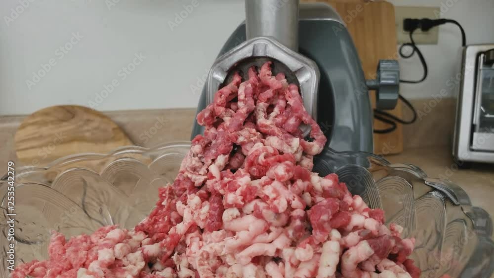 Home cooking - Close up of electric grinder while beef is being ...