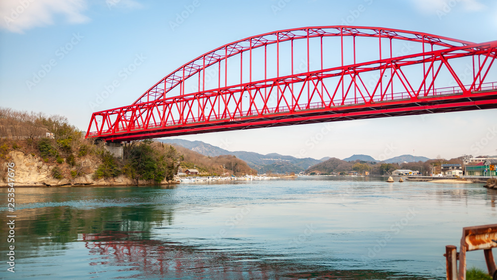 A red-colored bridge called 'Mukaishimao Bridge', which connects ...