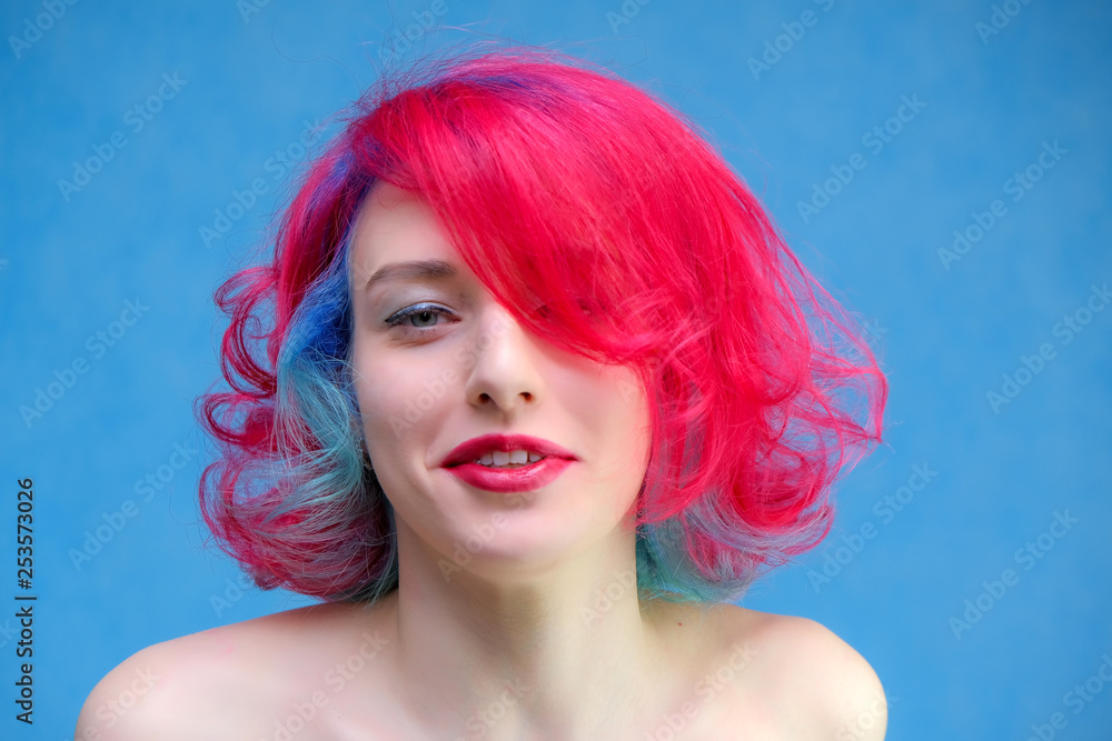High fashion model woman with multi-colored hair posing in the studio ...