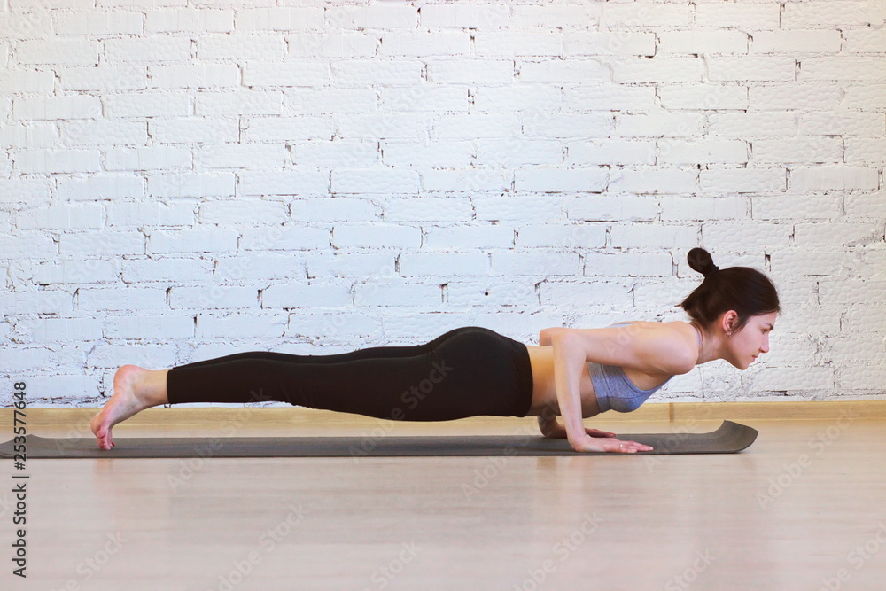 The girl is a professional instructor of hatha yoga practicing asanas ...