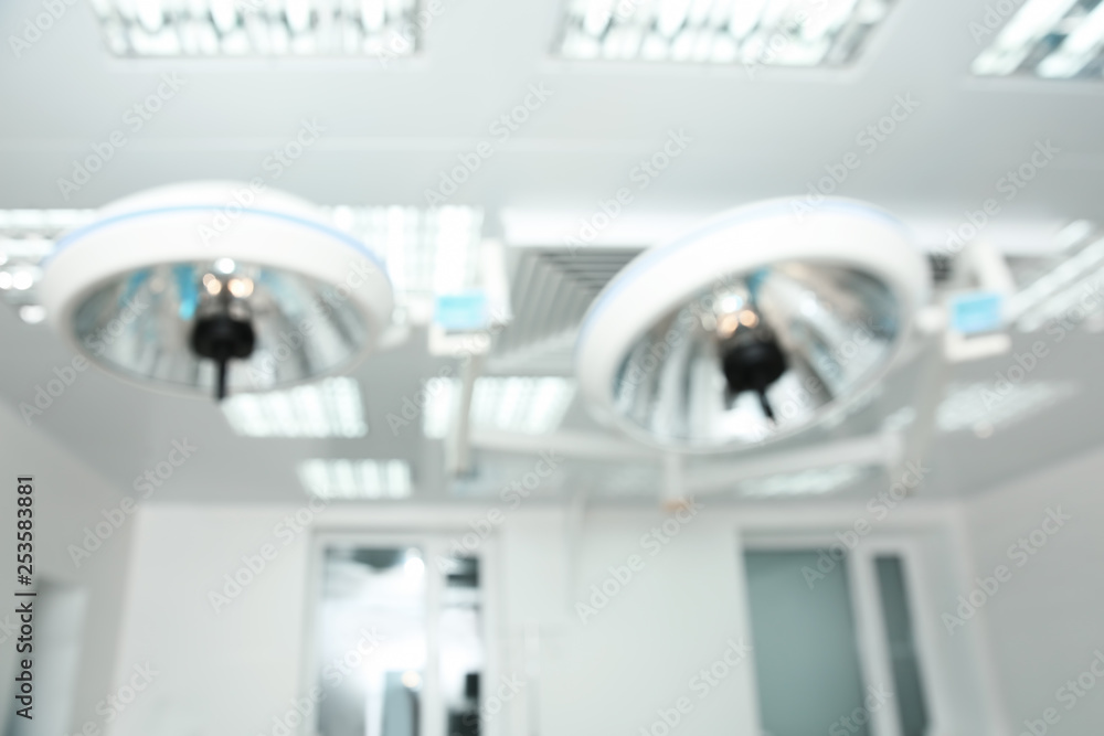 Blurred view of powerful surgical lamps in modern operating room Stock ...