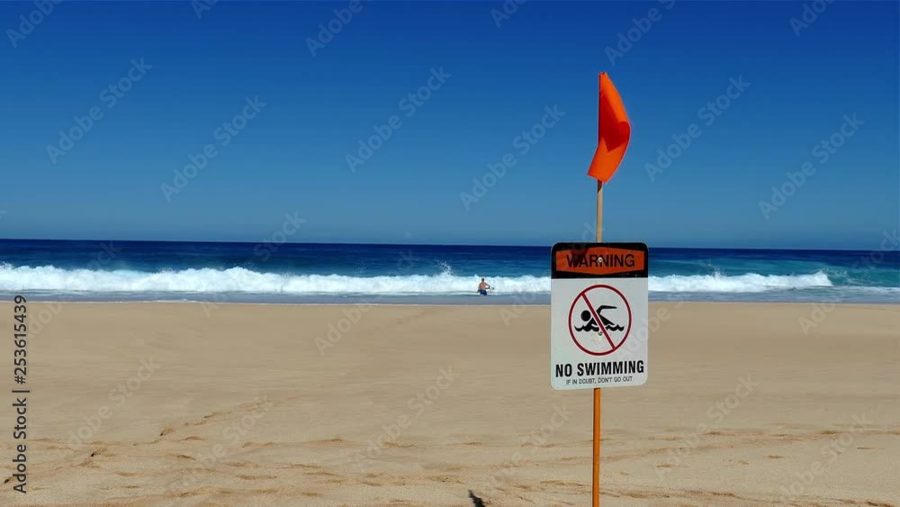 Video footage of a "No Swimming" sign posted at the beach on the North ...