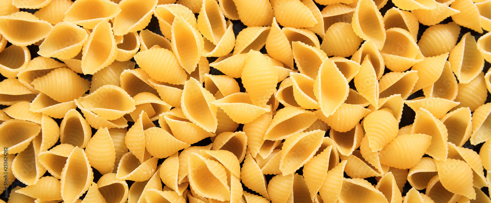 Uncooked macaroni shell shape pasta texture background, banner Stock ...