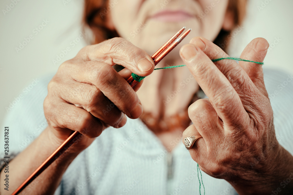 Wool. Woolen clothes. Hands of old woman knitting wool. Adult activity ...