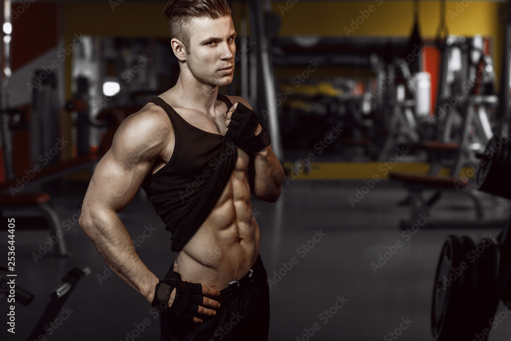 Muscular Model Young Man Exercising In Gym Portrait Of Sporty Strong