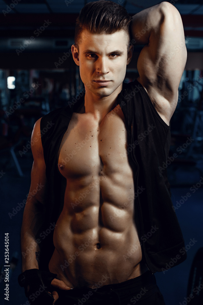 Muscular Model Young Man Exercising In Gym Portrait Of Sporty Strong