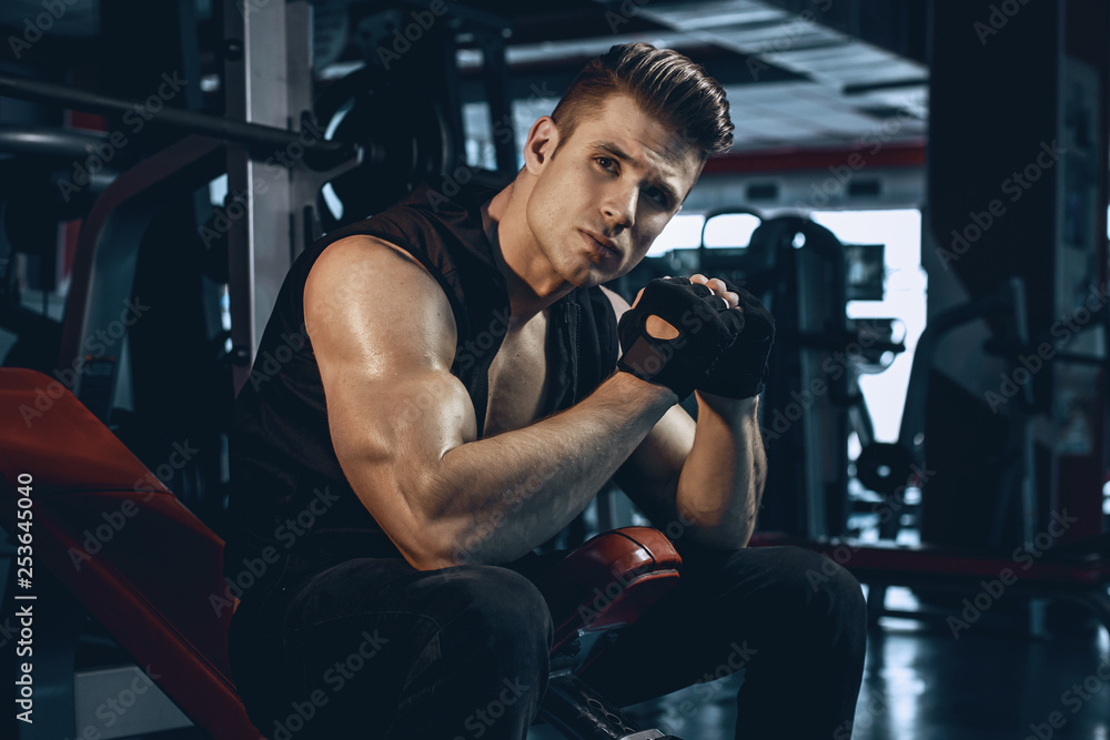 Muscular Model Young Man Exercising In Gym Portrait Of Sporty Strong