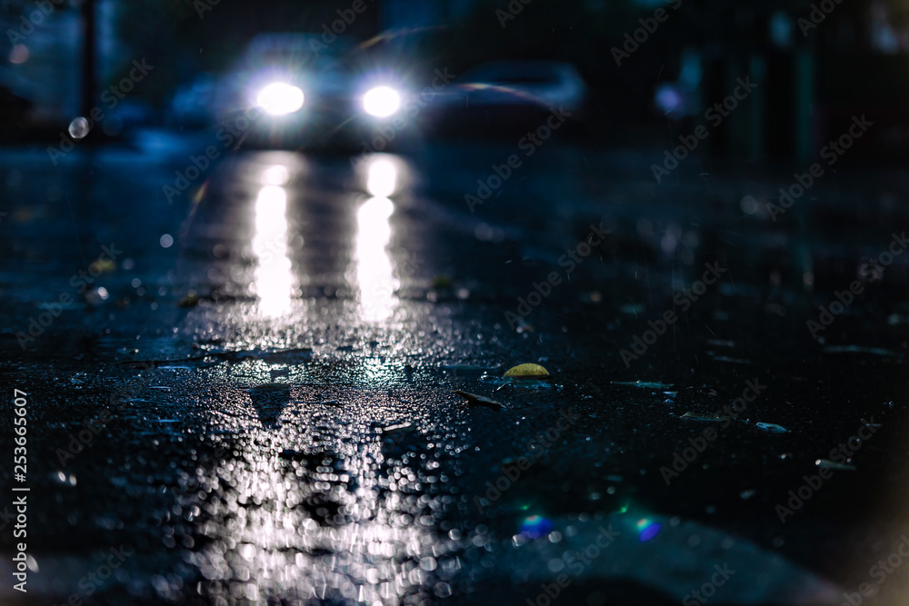 Motion car in rain, water spray. Night road blurred, headlight of car ...
