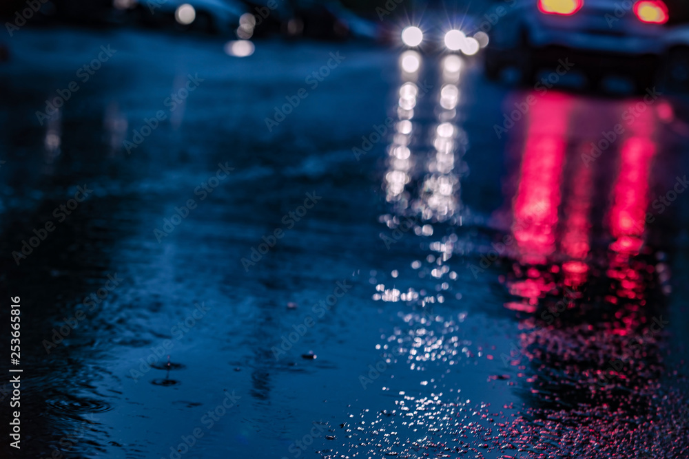Night road blurred. Headlight of car in the dark while heavy raining ...